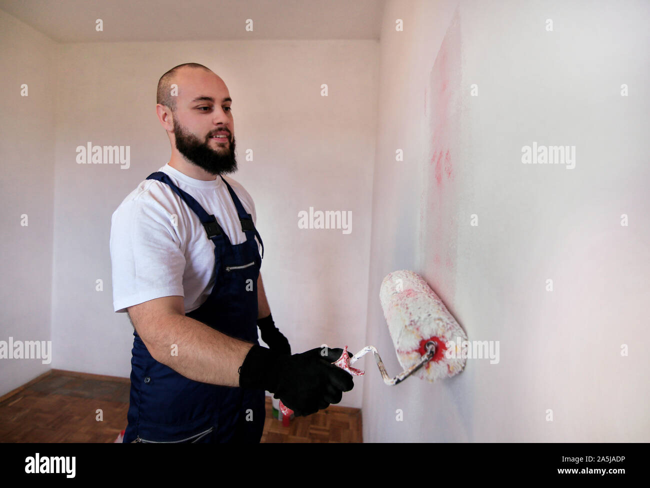 Construction worker doing finish renovation at apartment. Professional ...