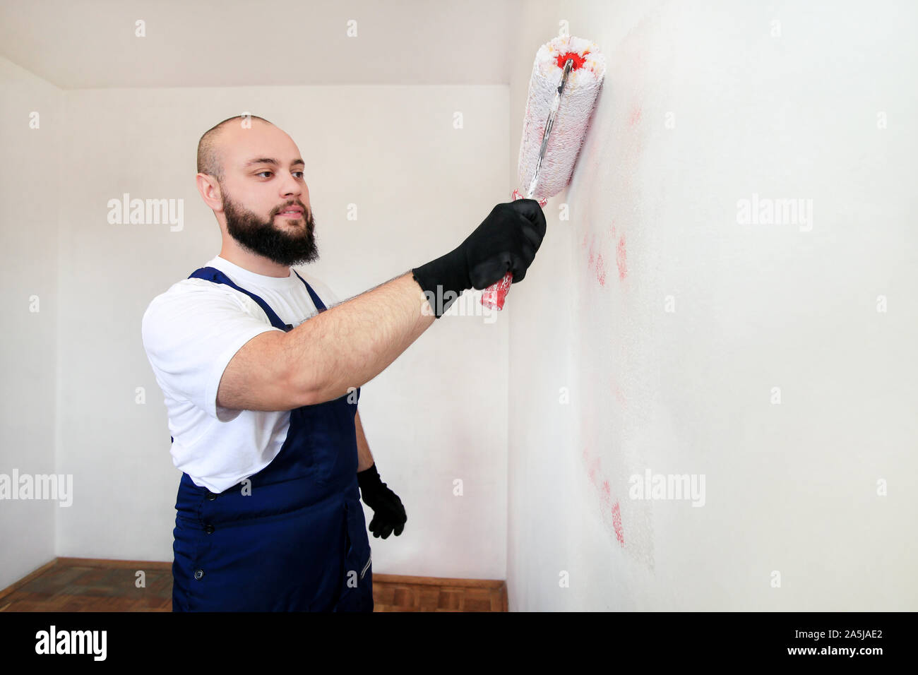 Construction worker doing finish renovation at apartment. Professional ...