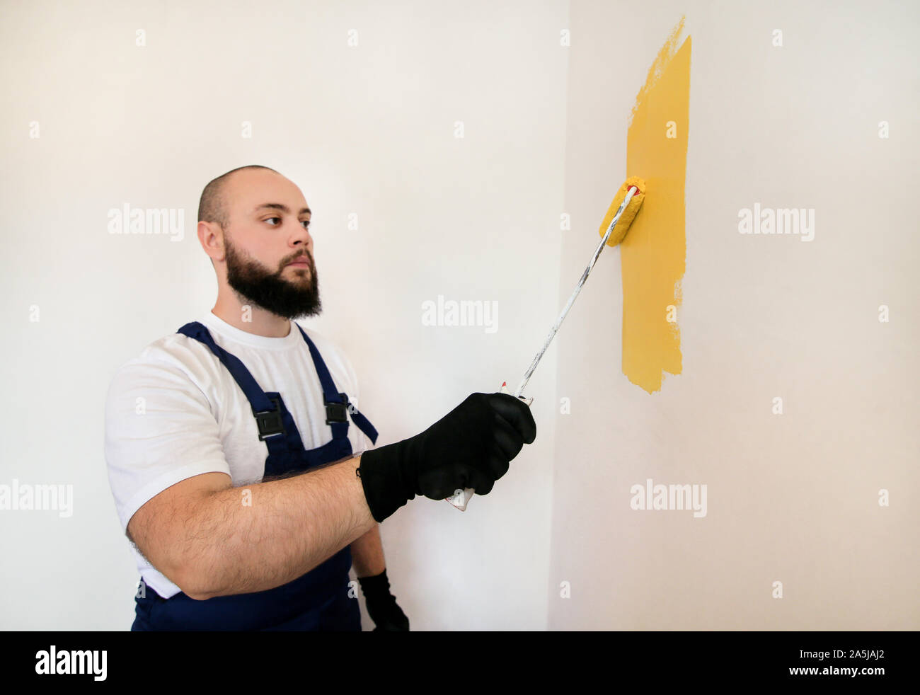 Construction worker doing finish renovation at apartment. Professional ...