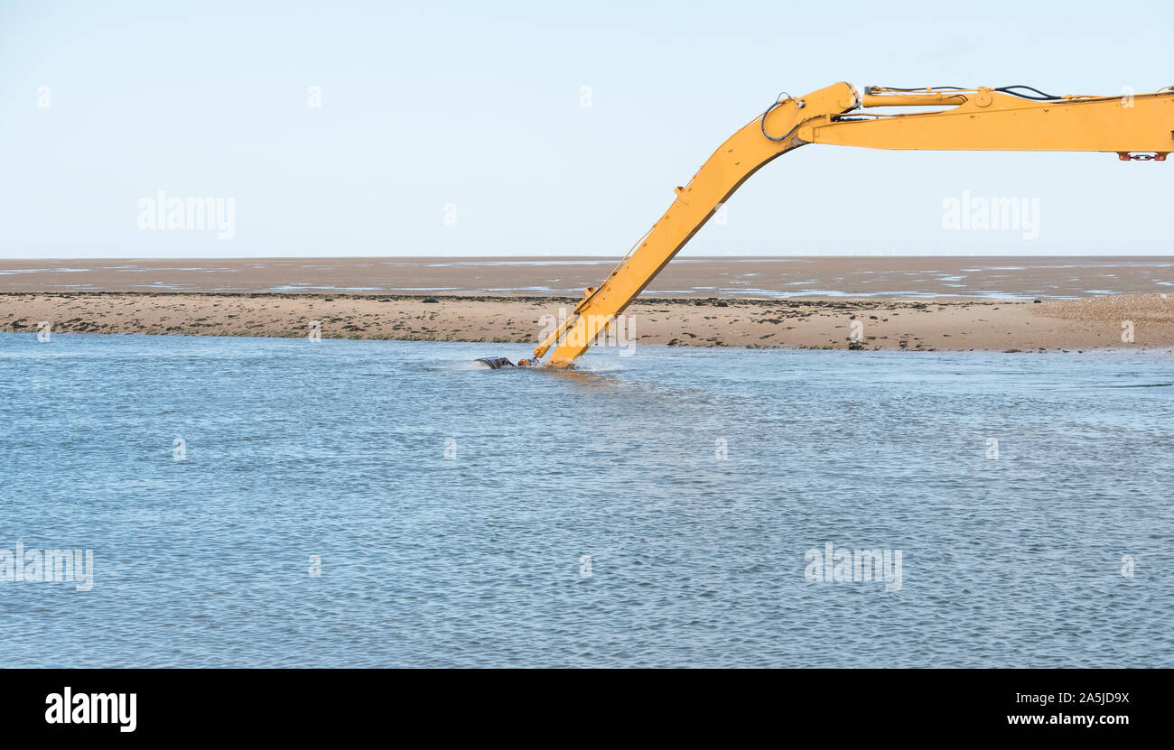 Excavator arm submerged in the sea Stock Photo - Alamy