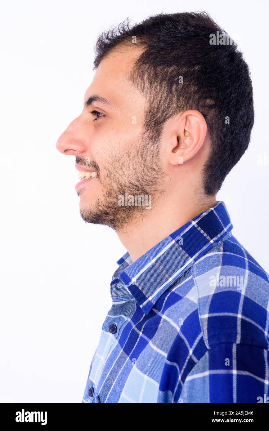 Closeup profile view of happy young bearded Persian hipster man smiling ... Closeup profile view of happy young bearded Persian hipster man smiling ...