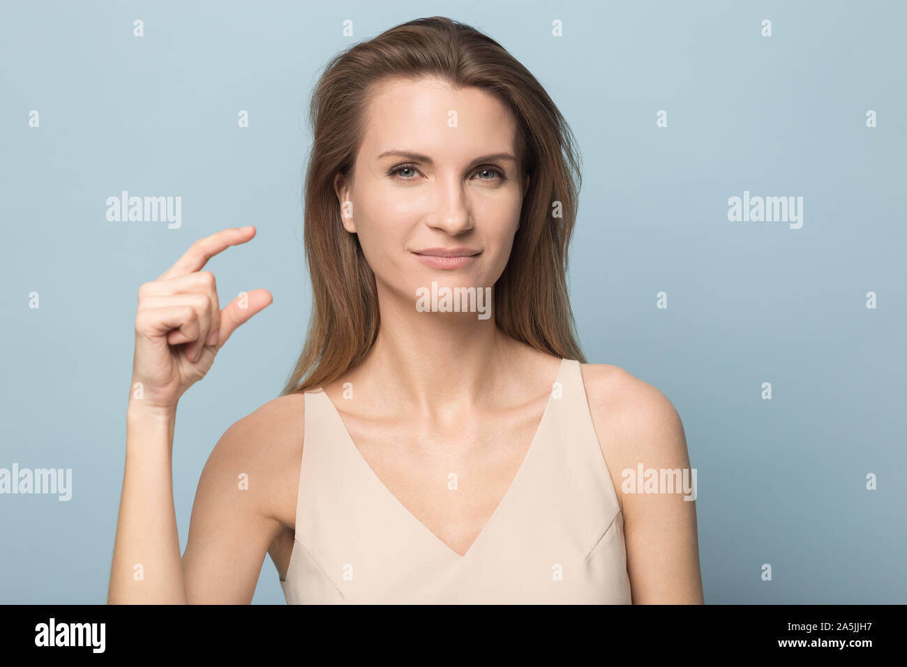 Millennial woman show small size measurement or little prices Stock ...