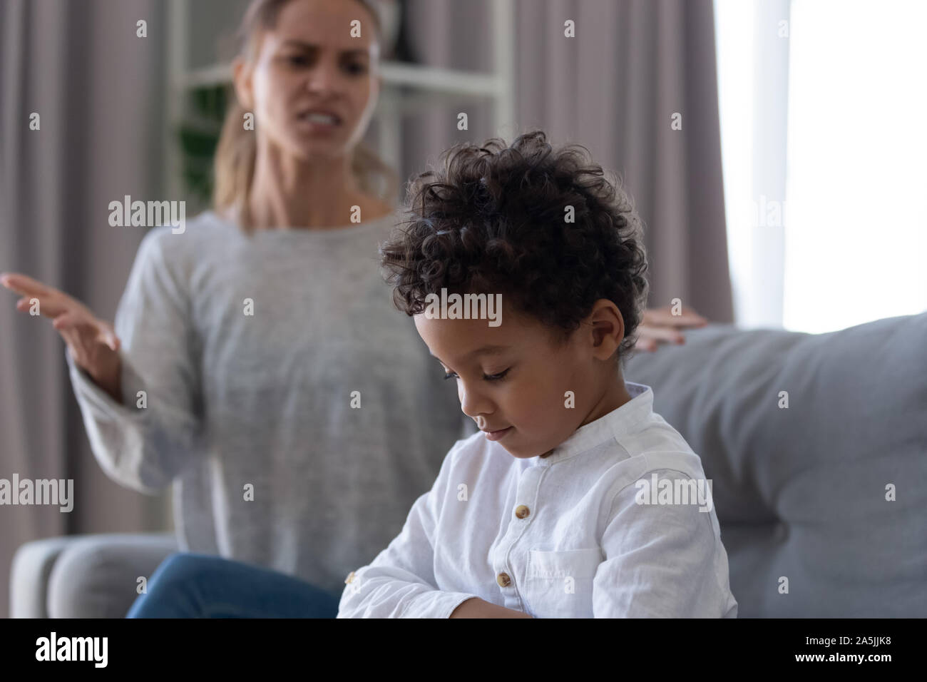 Little biracial boy ignore angry mom talking Stock Photo - Alamy