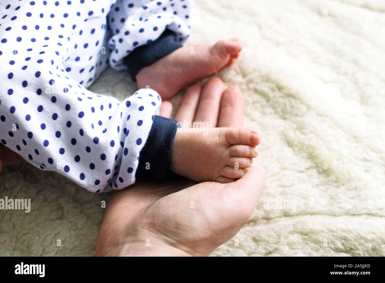 Hand touching feet hi-res stock photography and images - Alamy