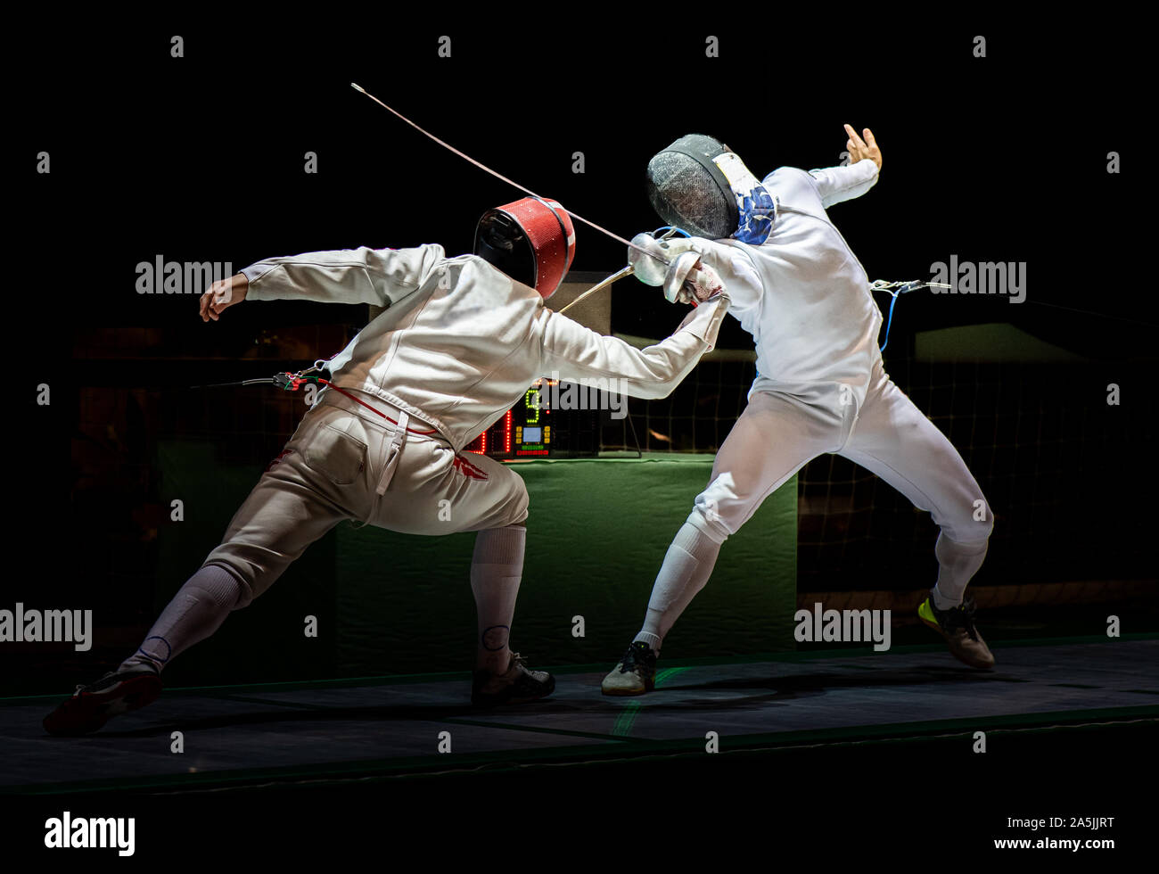 Two fencing athletes fight on professional sports arena Stock Photo - Alamy