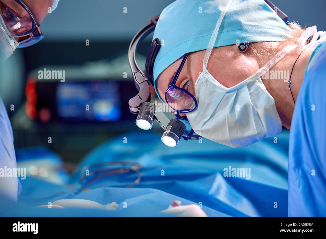 Close up portrait of female surgeon doctor wearing protective mask and ...