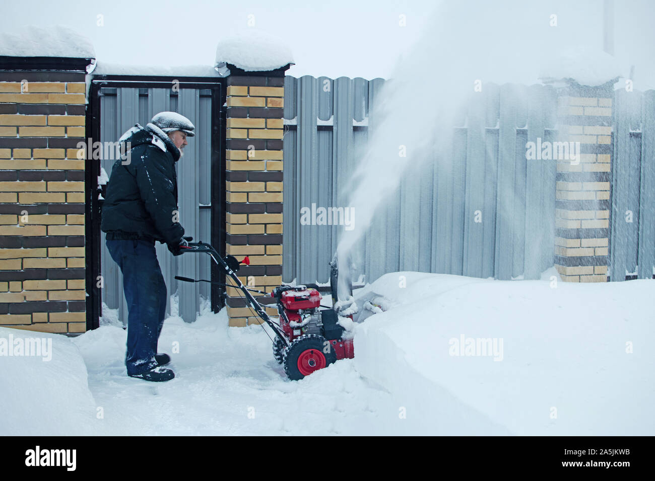 Snow clearing. Snowblower clears the way after heavy snowfall Stock ...