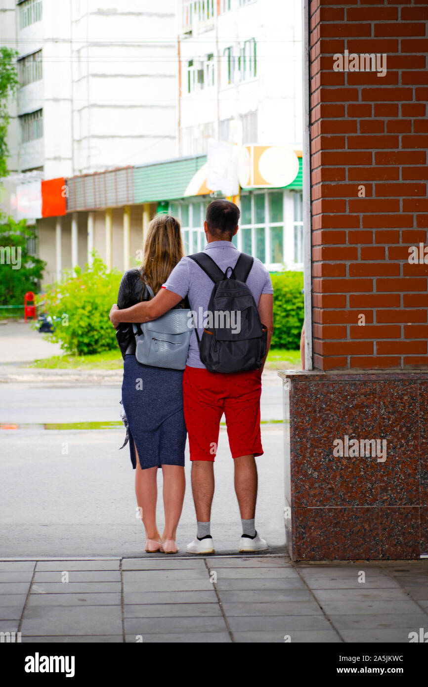Back view of beautiful couple hugging and looking outdoors Stock Photo ...
