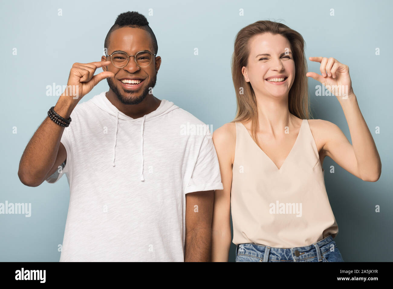 Smiling multiracial man and woman laugh showing small size measurements ...