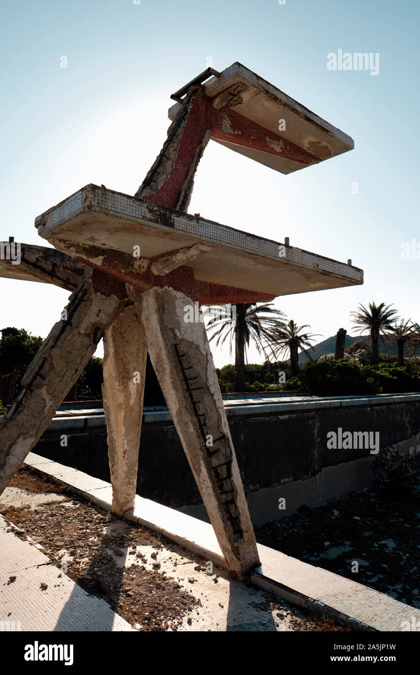 The empty Funtanazza hotel complex swimming pool diving board, a ...