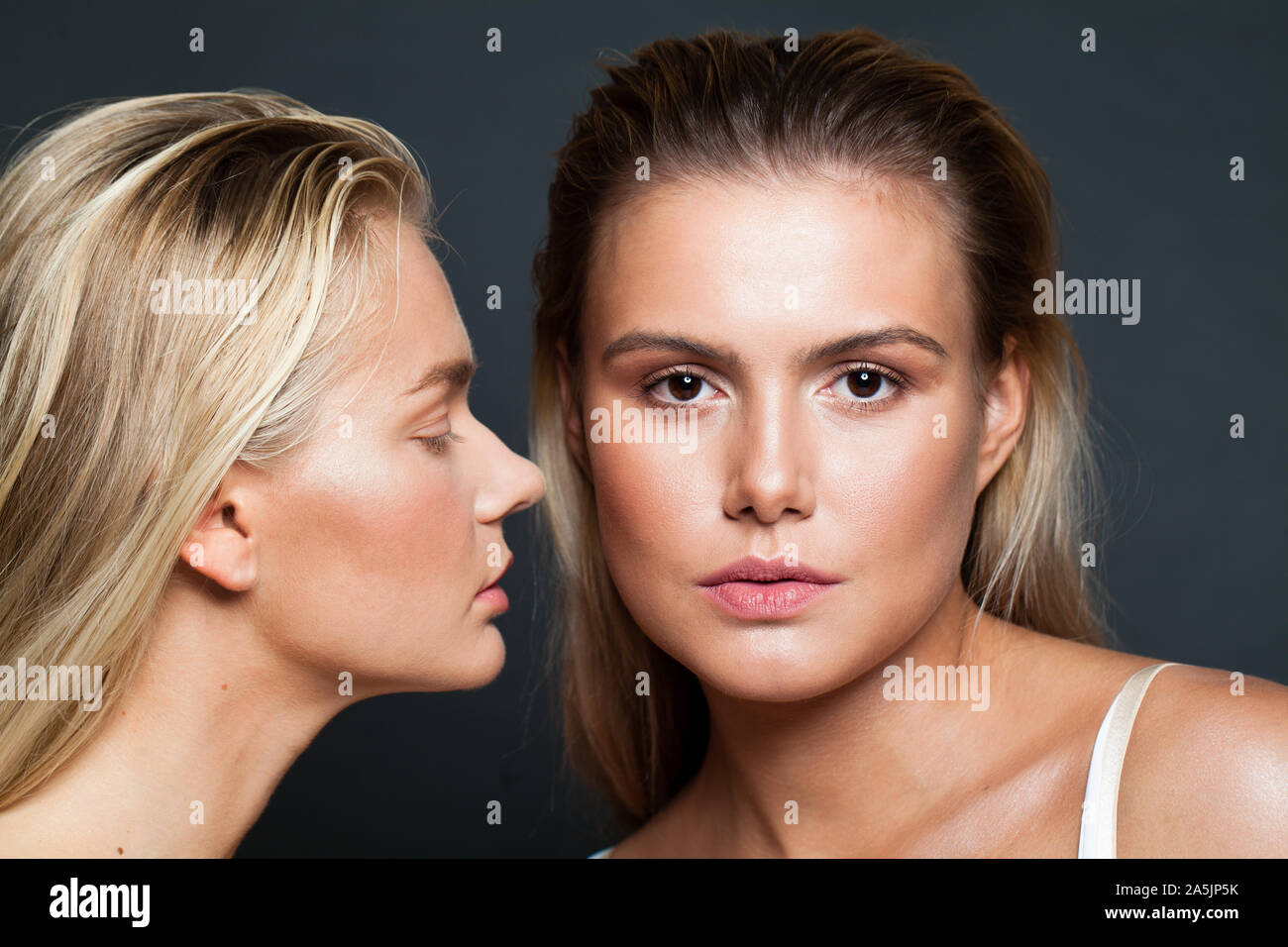 Two pretty women faces, closeup portrait Stock Photo - Alamy