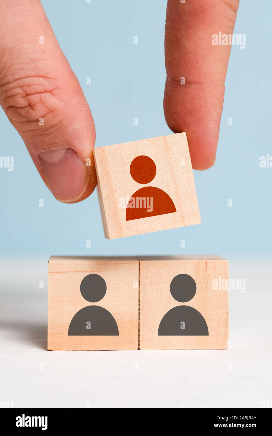 Cubes made of wood on a blue background. Concept of a new team leader ...