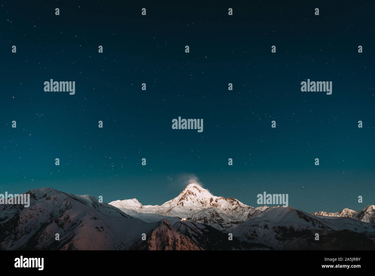 Gergeti, Georgia. Winter Night Starry Sky With Glowing Stars Over Peak ...