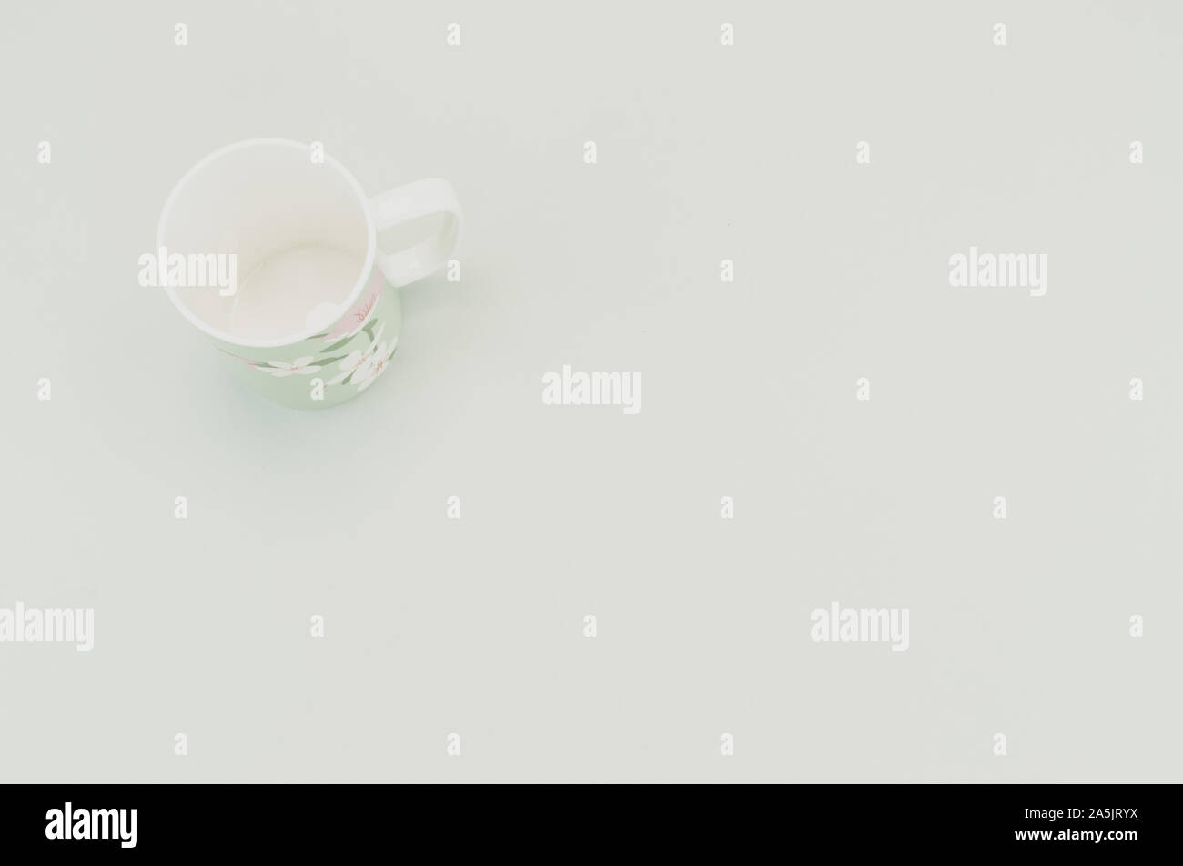 empty modern white decorated green mug on a blank surface - directly ...