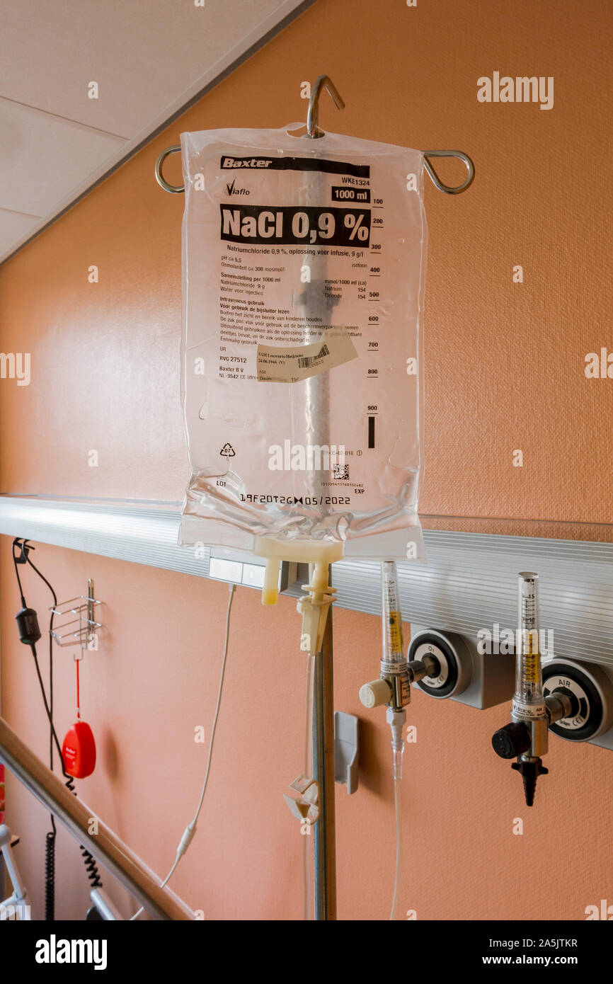 Intravenous drip bag hangs in a hospital room feeding salt solution to ...