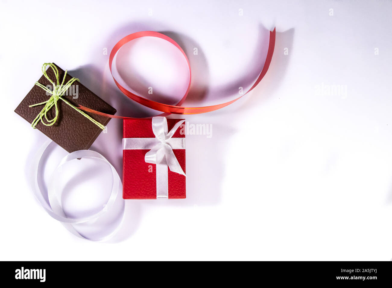 Decorated red and brown gift boxes with white and red ribbon around on ...