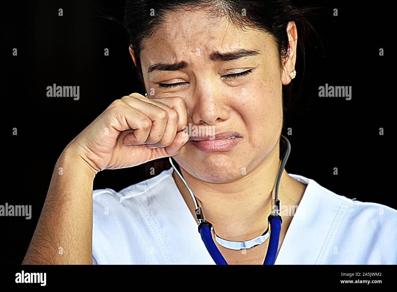 Crying Female Nurse Wearing Scrubs Stock Photo - Alamy