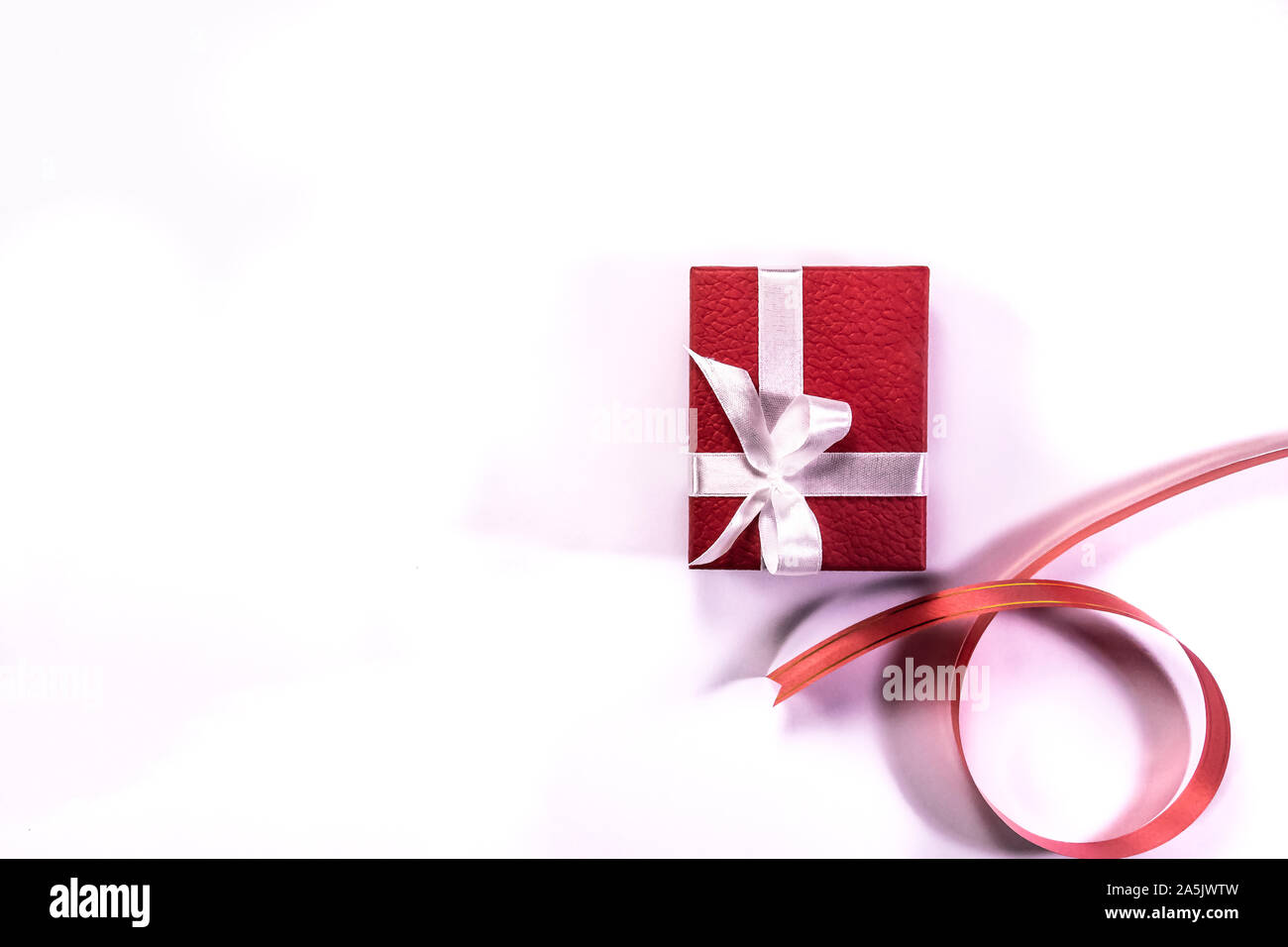 Red gift box with white ribbon isolated on white background with copy ...
