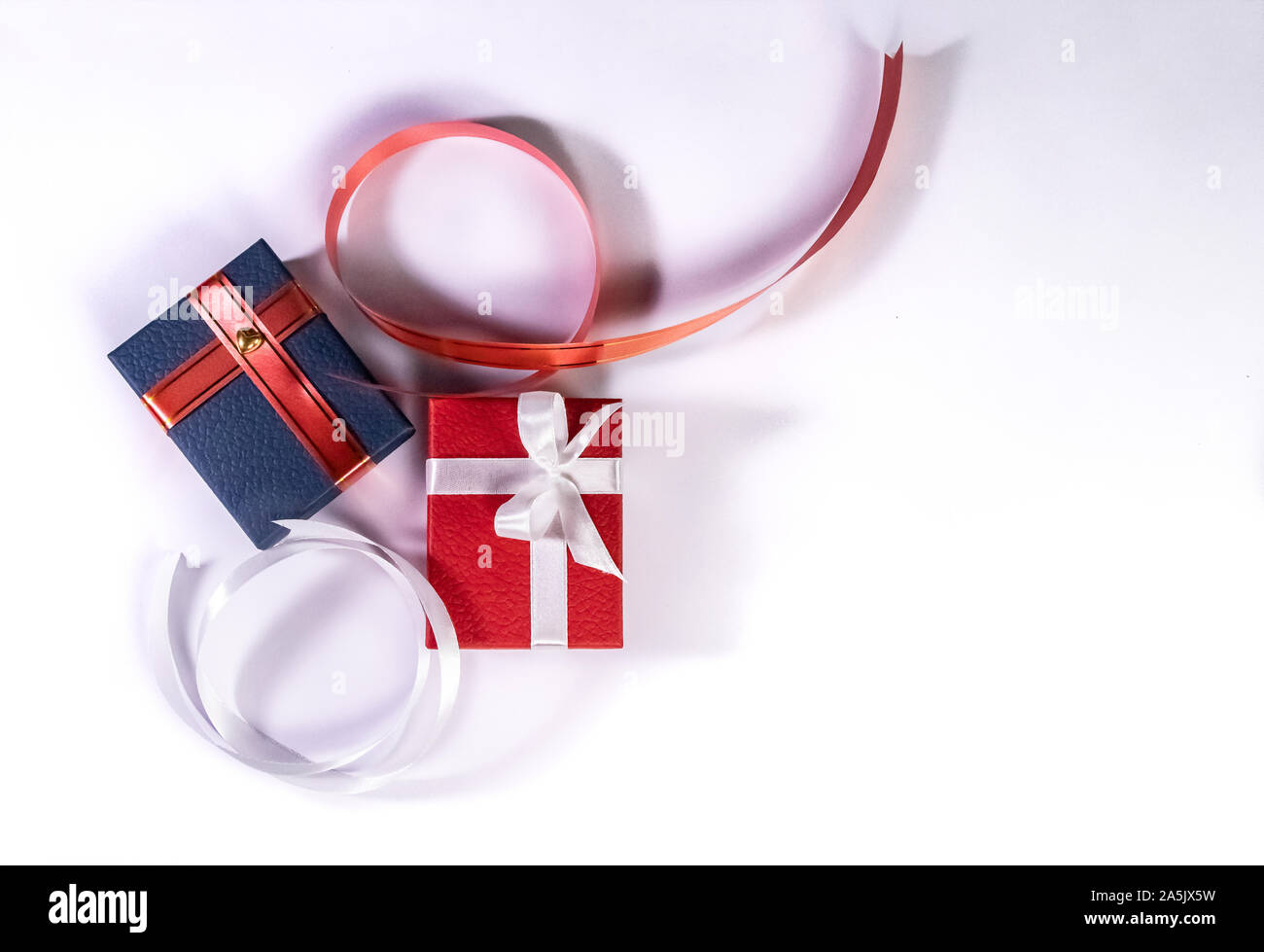 Romantic red and blue gift boxes with white and red ribbons around on ...