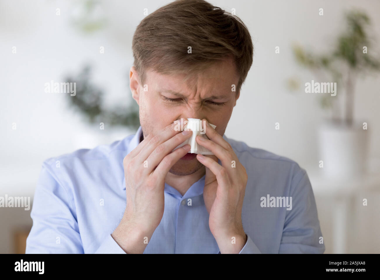 Head shot middle aged unhealthy businessman suffering from runny nose ...