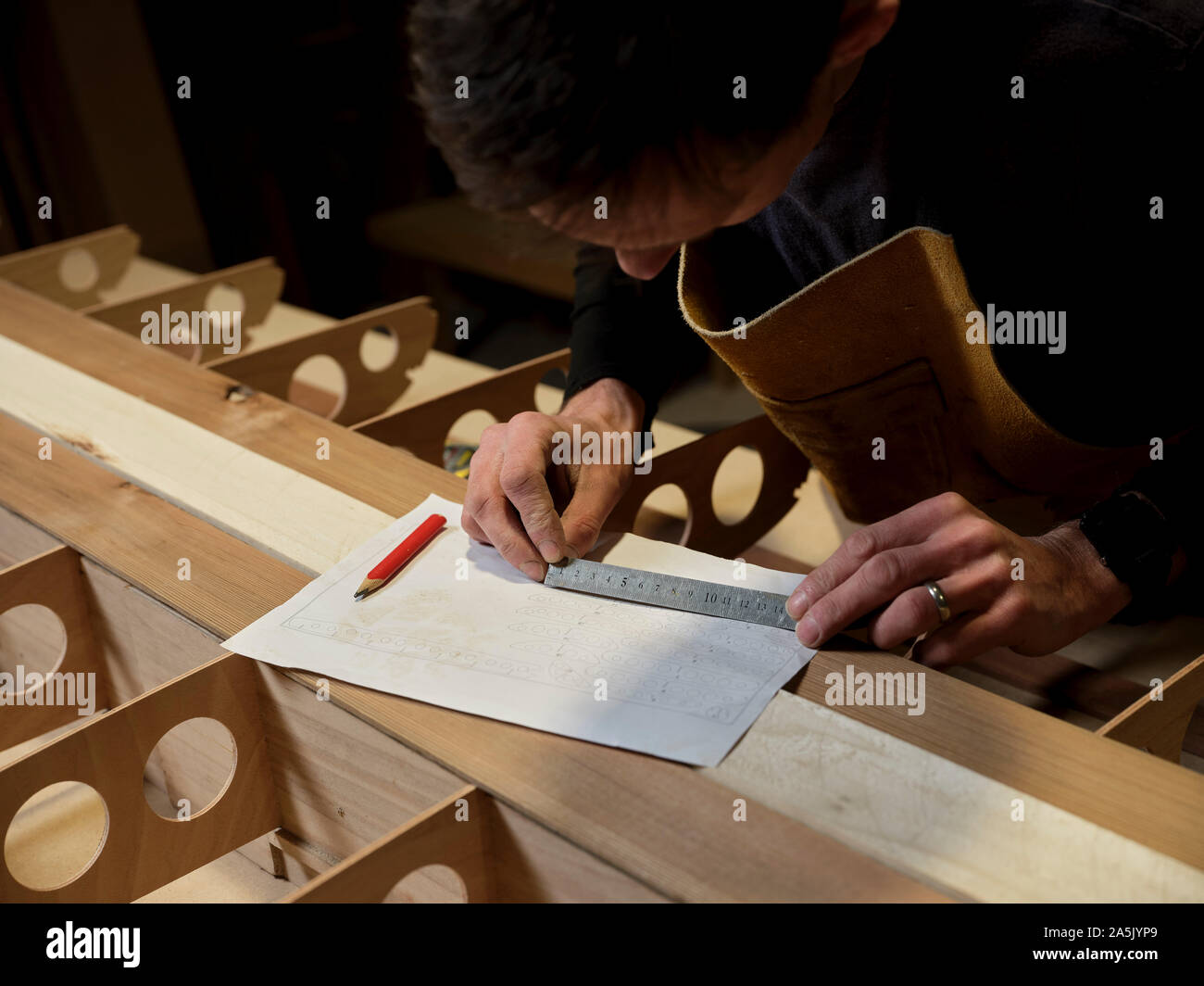Man using metal ruler in design workshop Stock Photo - Alamy
