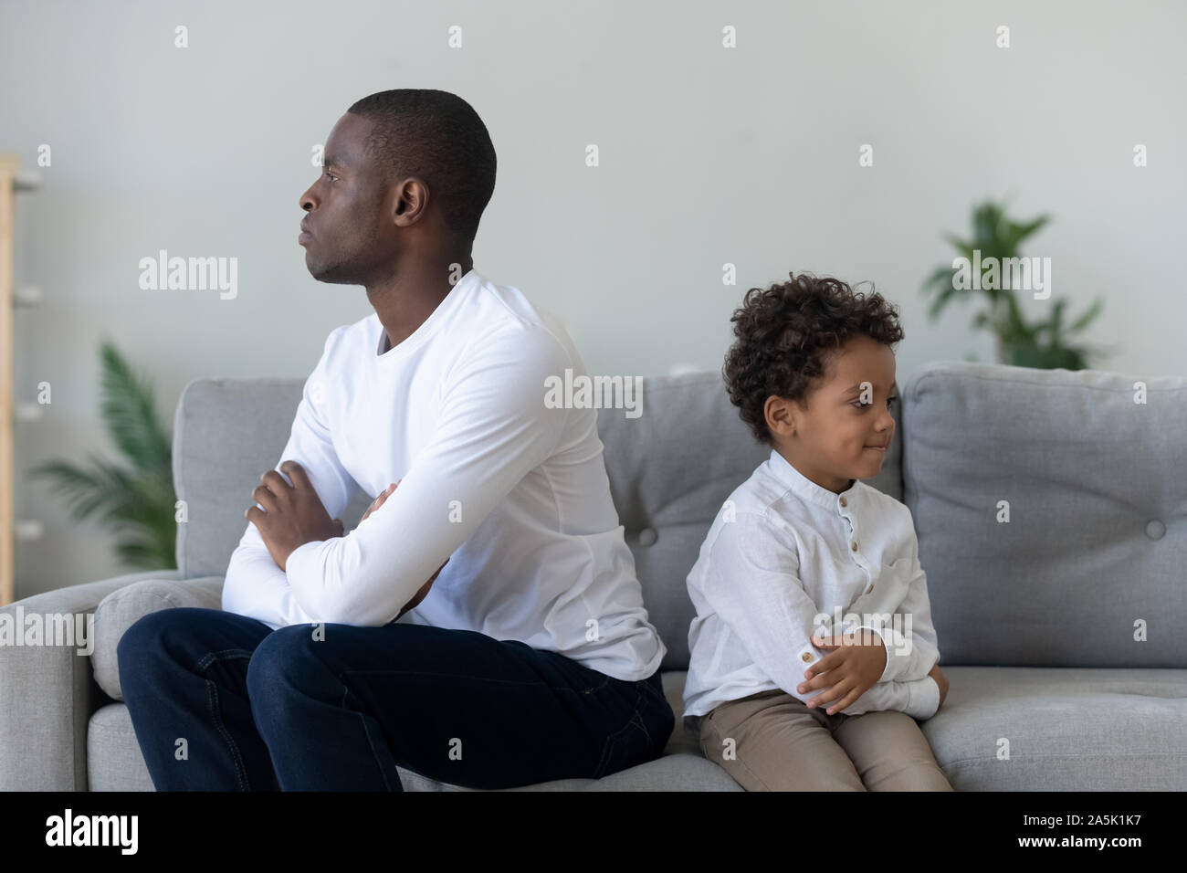 Ethnic dad and little son avoid talking after conflict Stock Photo - Alamy