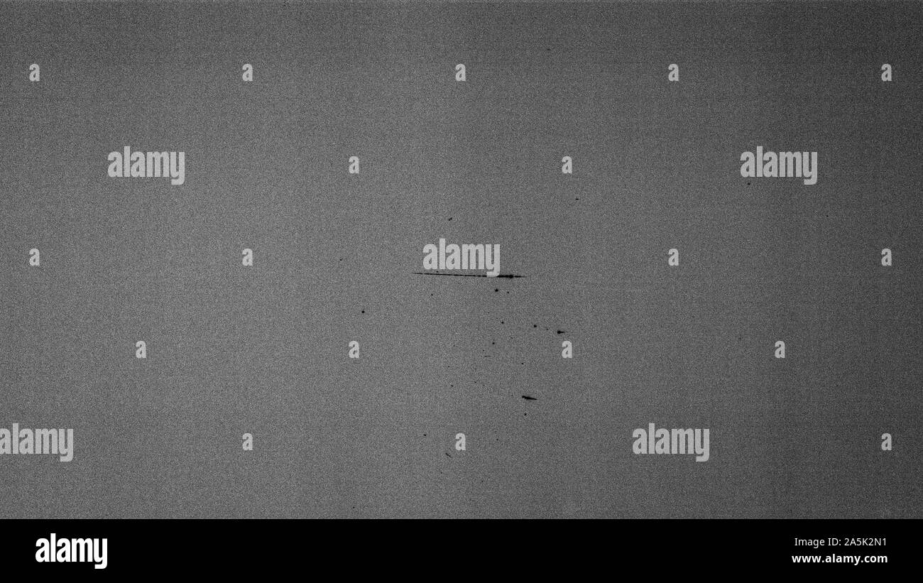 Noisy film frame with heavy noise, some scratches and grain. Abstract ...