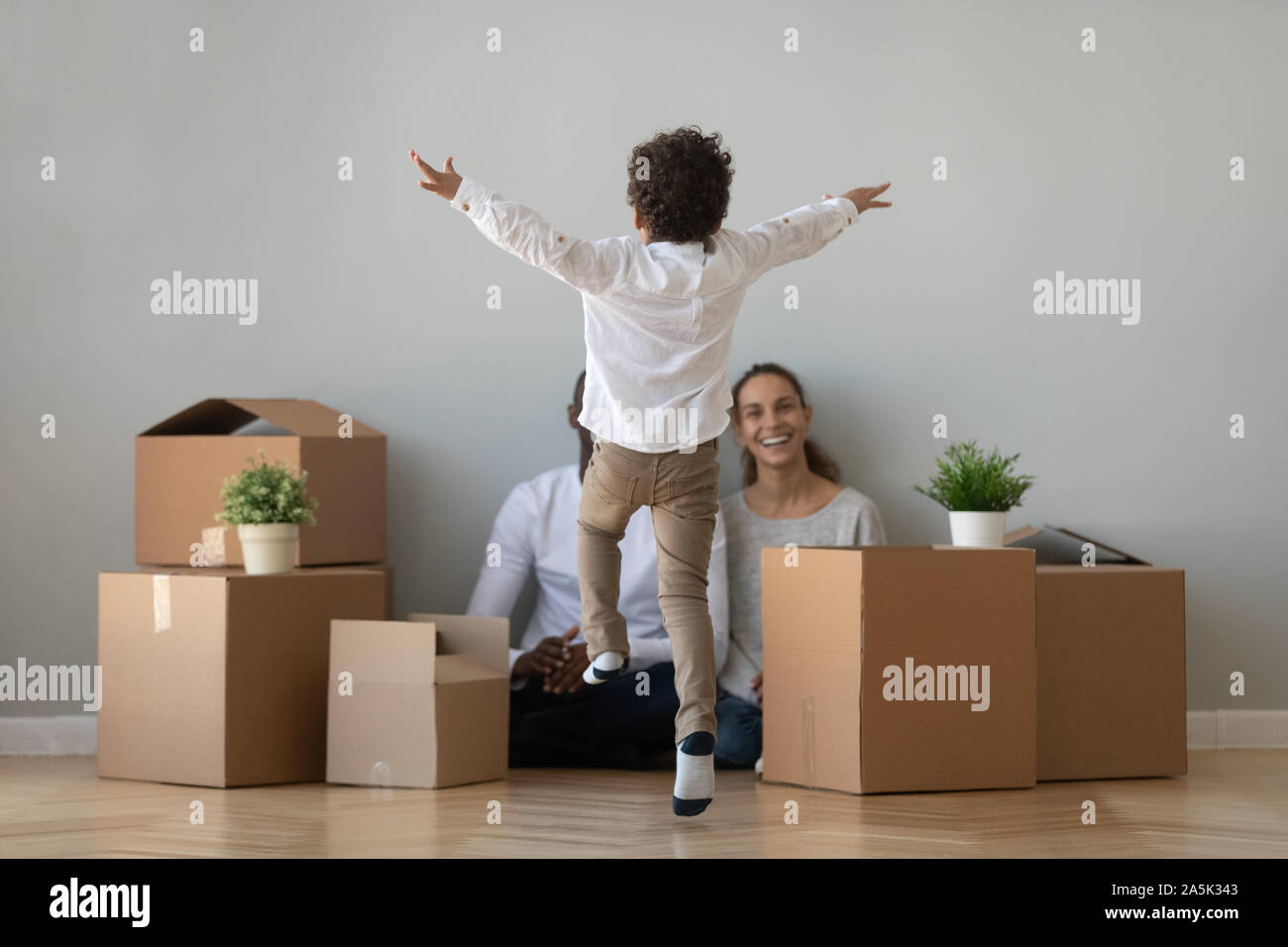 Excited little boy jump happy for family moving Stock Photo - Alamy