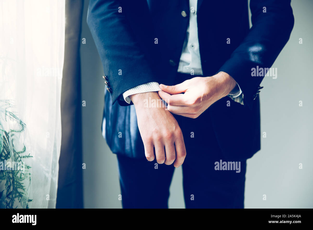 Man adjusting cufflinks hi-res stock photography and images - Alamy