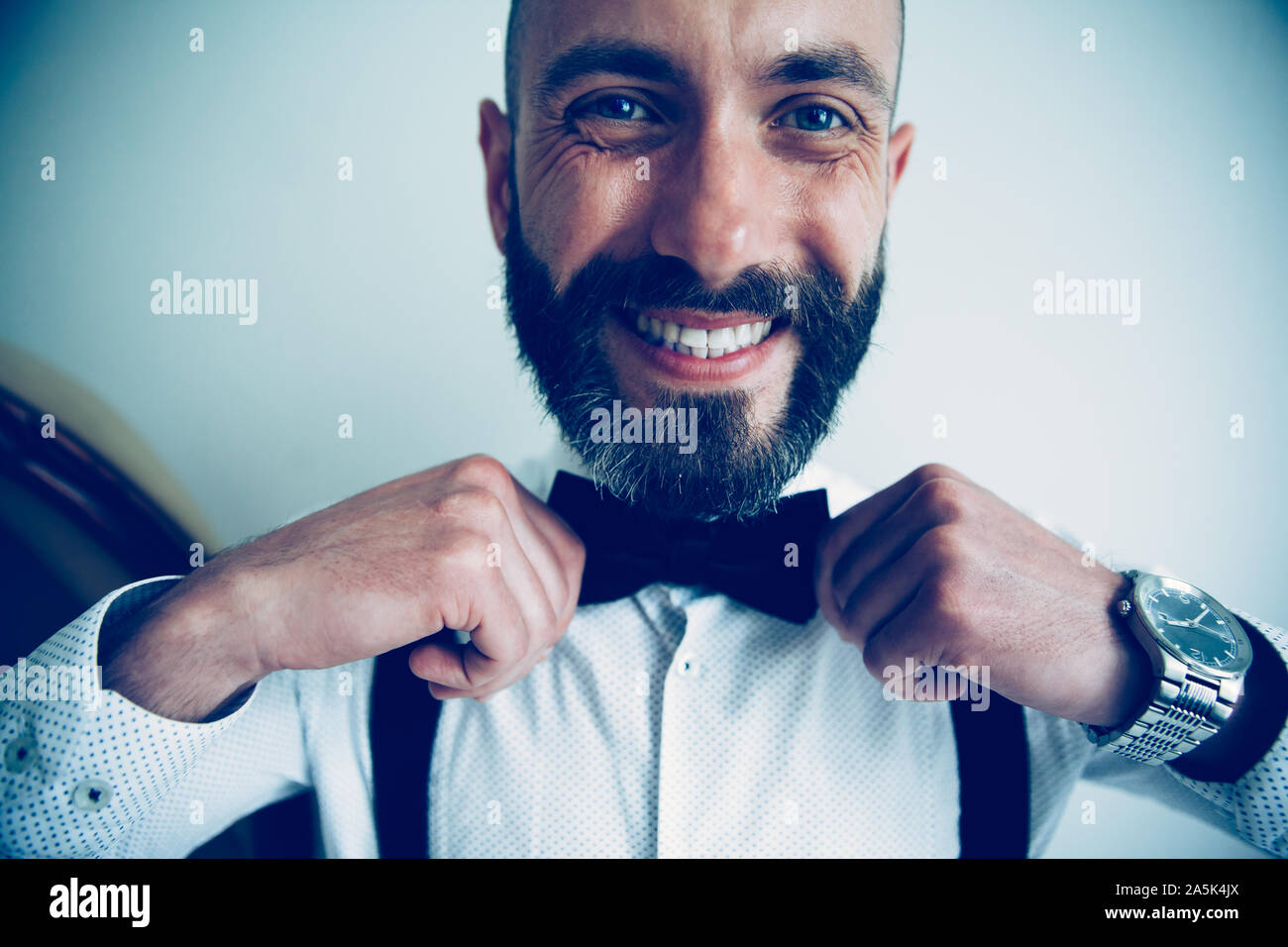 Man adjusting bow tie hi-res stock photography and images - Alamy