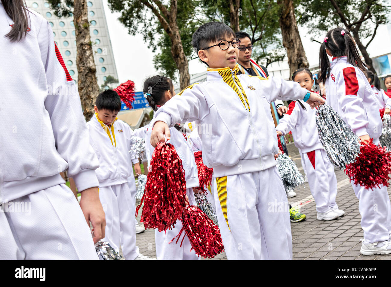 Young Chinese children rehearse cheerleading routines at Statue Square ...