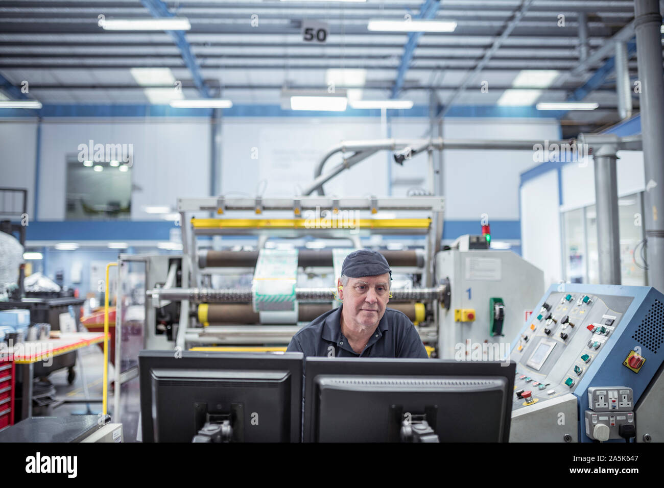 Worker inspecting packaging factory hi-res stock photography and images ...
