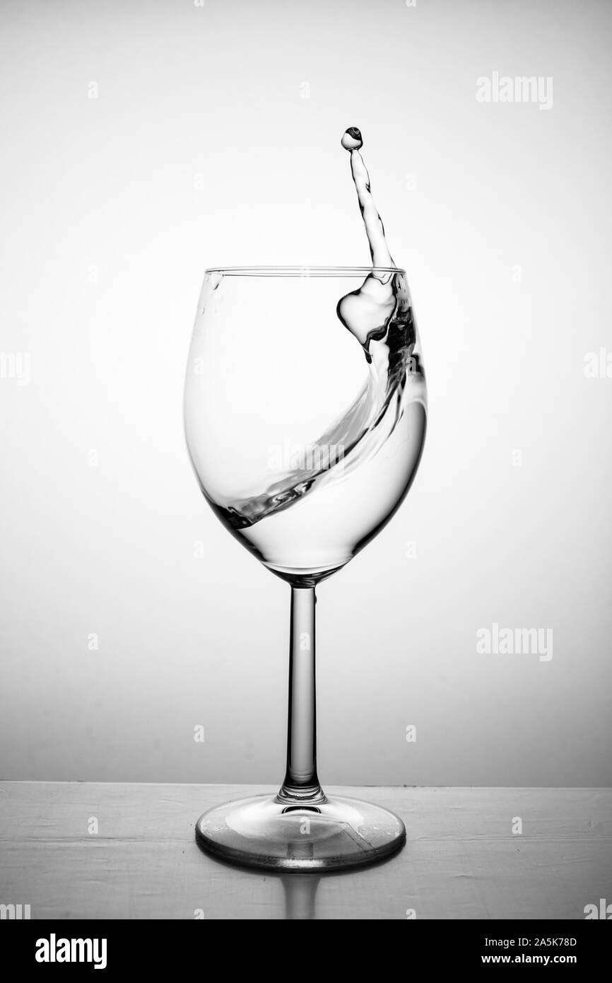 Glass with water up and splash Stock Photo - Alamy