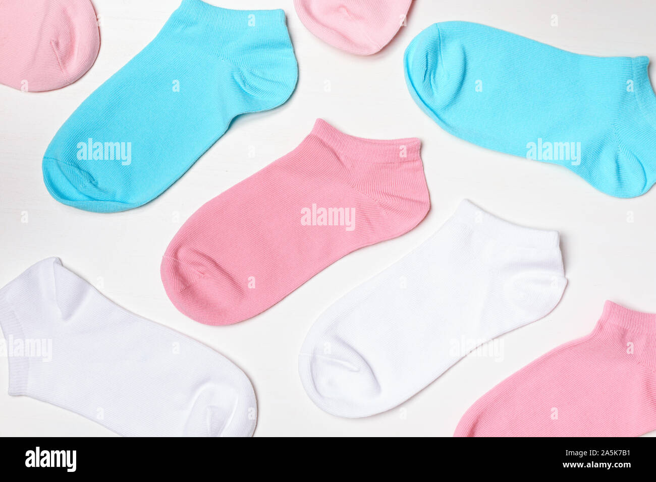 Multi-colored socks on a white background. Top view Stock Photo - Alamy