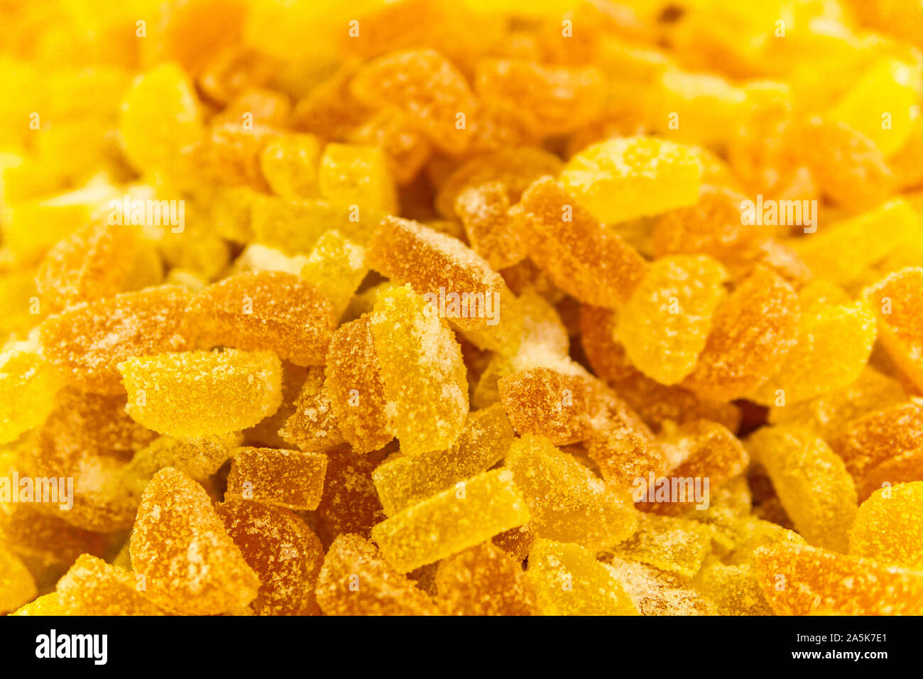 background - golden yellow translucent fruit gumdrops in sugar Stock ...