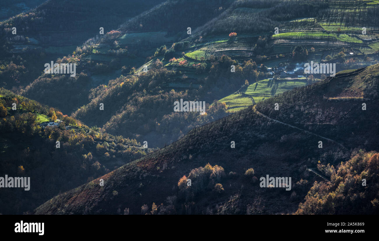 Old rounded mountains with villages surrounded by deciduous forests and ...