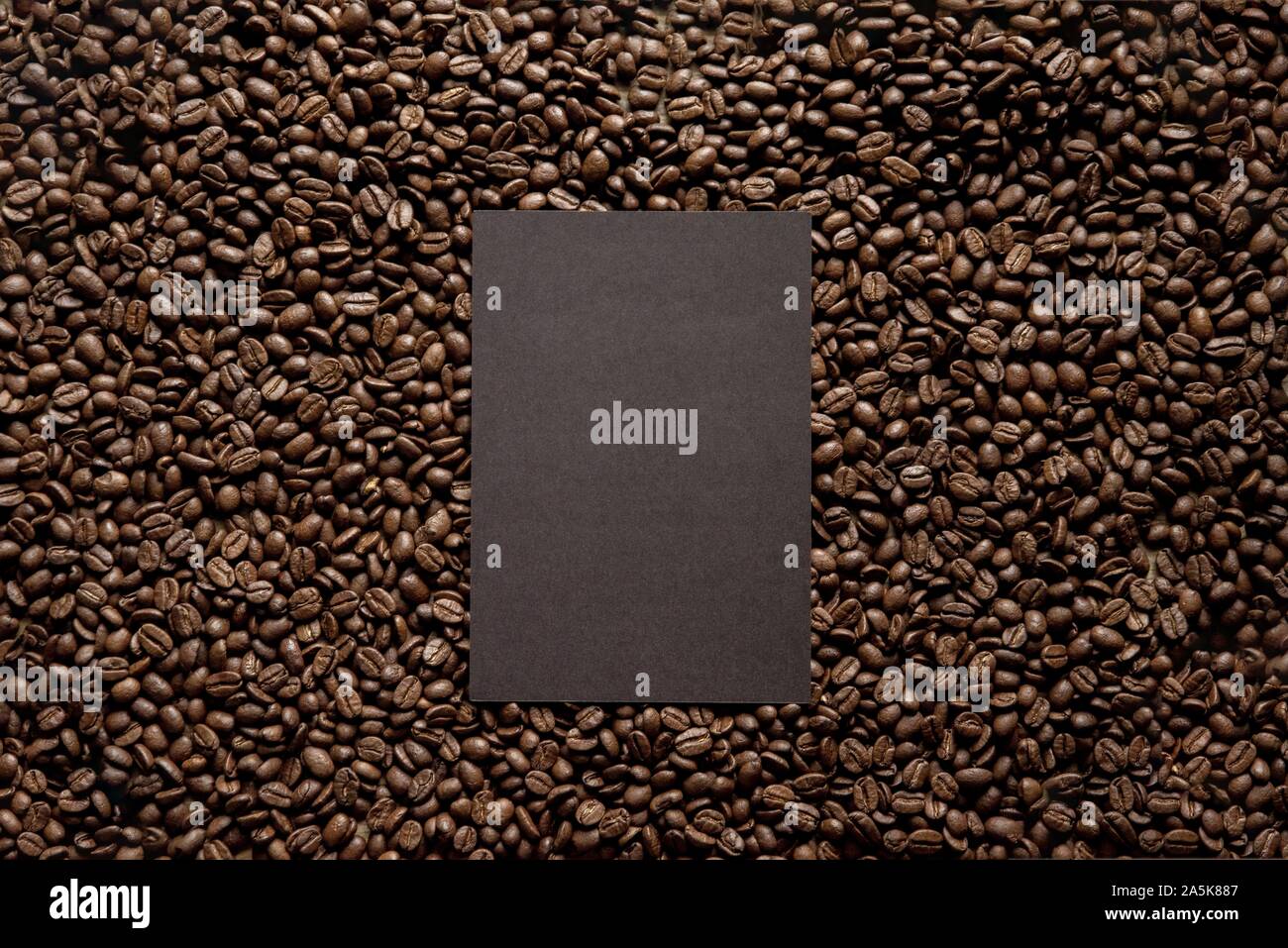 Overhead shot of a black rectangle over coffee beans great for writing ...