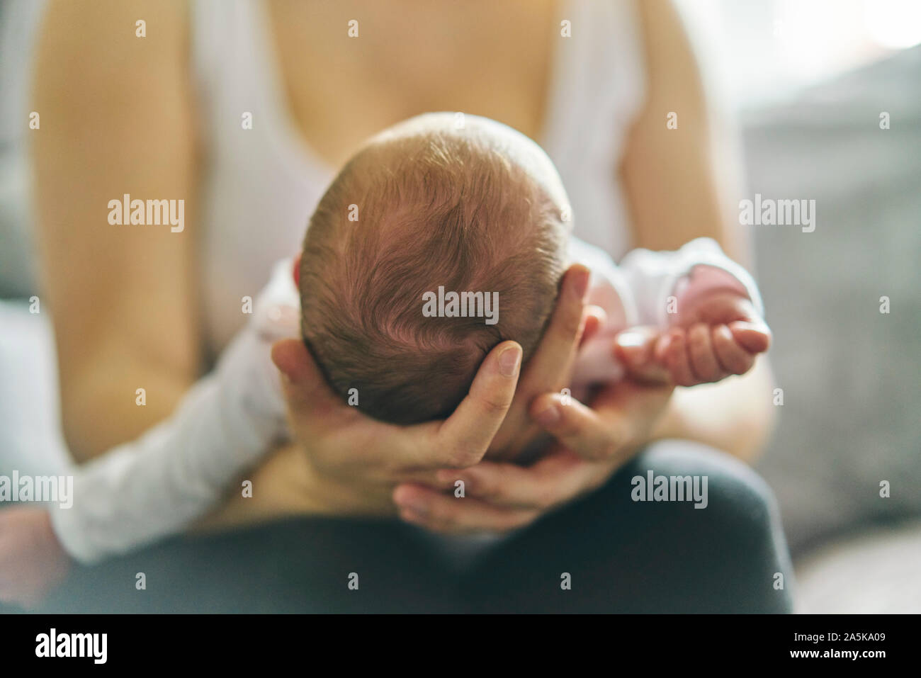 Mother supporting baby on lap hi-res stock photography and images - Alamy