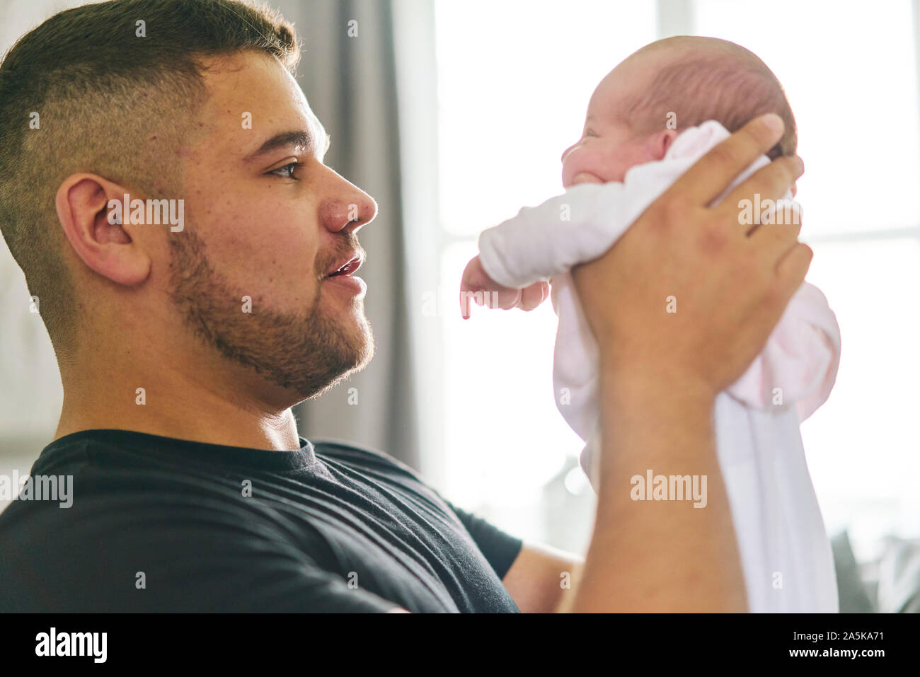 Baby in arms hi-res stock photography and images - Alamy