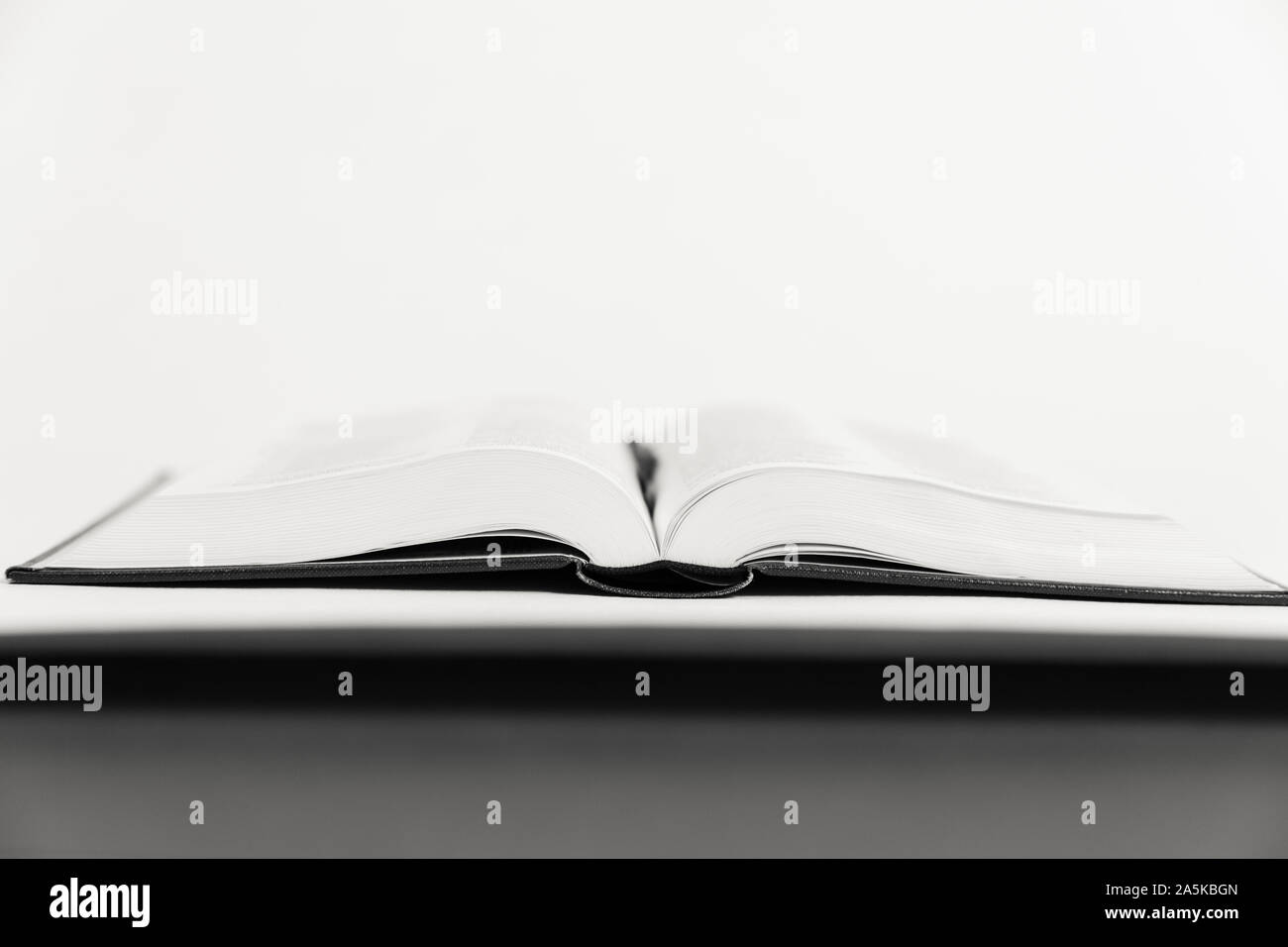 An open book on a table Stock Photo - Alamy