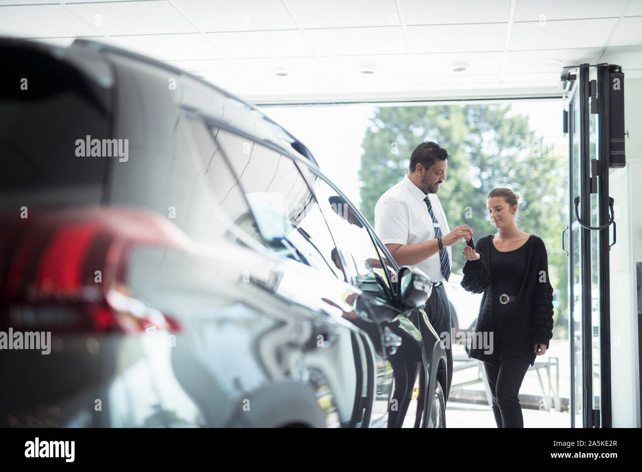 Woman handing over the car keys hi-res stock photography and images - Alamy