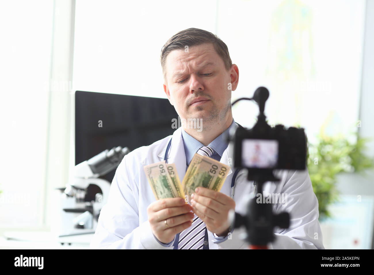 Medical doctor counting money concept hi-res stock photography and ...