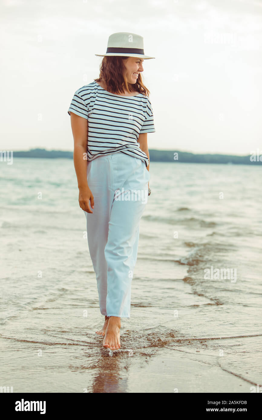 woman in white clothes walking by sea beach Stock Photo - Alamy