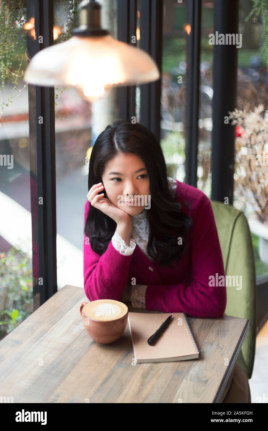 Woman sitting wooden table on hi-res stock photography and images - Alamy