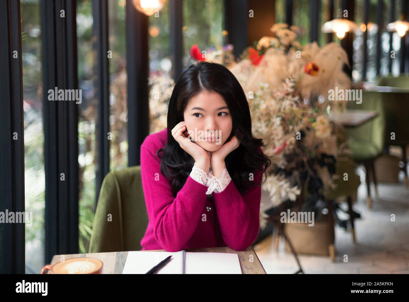 Beautiful young woman sitting table hi-res stock photography and images ...