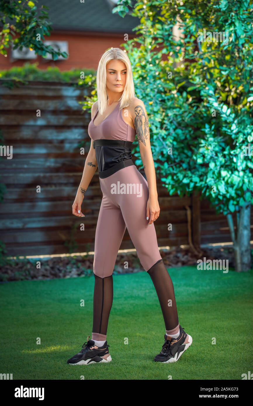 Beautiful fitness model girl posing wearing sport clothes. Girl in the ...