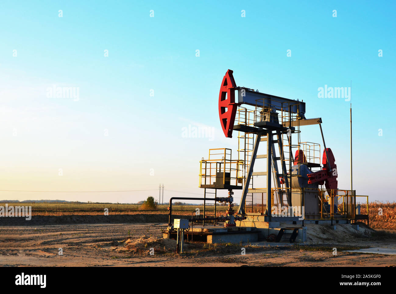 Oil drilling derricks at desert oilfield. Crude oil production from the ...