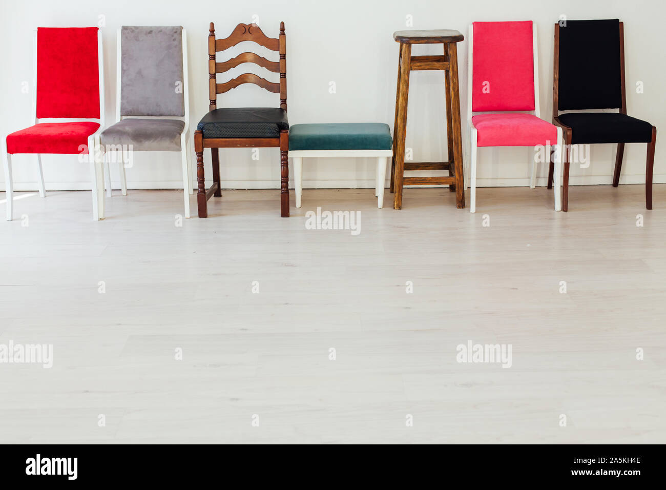 seven chairs in the interior of an empty white room Stock Photo - Alamy