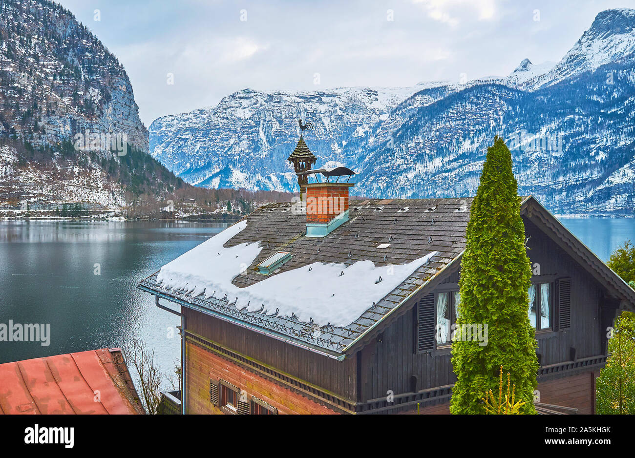 The view on snowy Dachstein Alps and dark waters of Hallstattersee lake ...