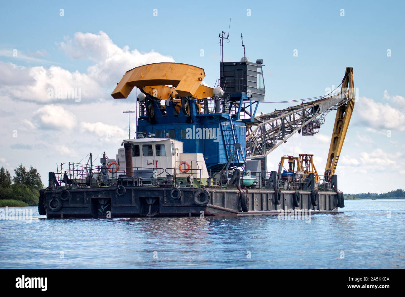 Floating river crane (barge derrick) in the vastness of the river ...